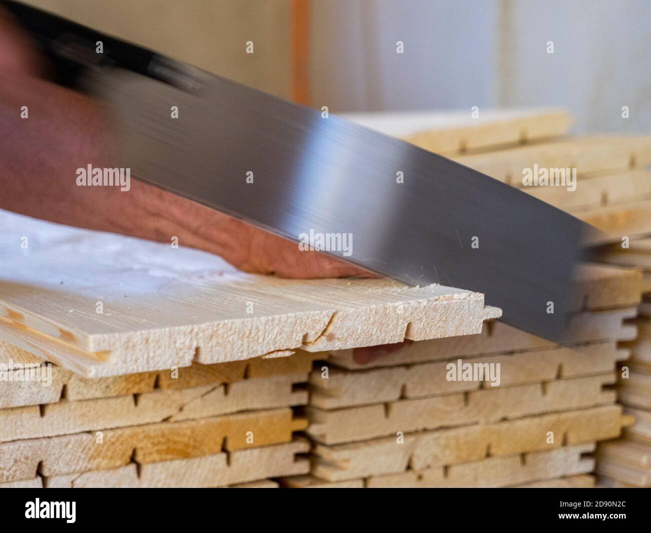 worker cuts wooden slats with saw Stock Photo - Alamy