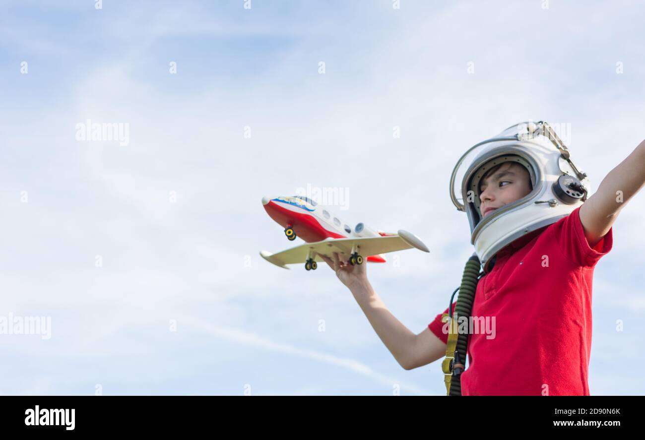boy with astronaut helmet and plane, playing to be pilot Stock Photo ...