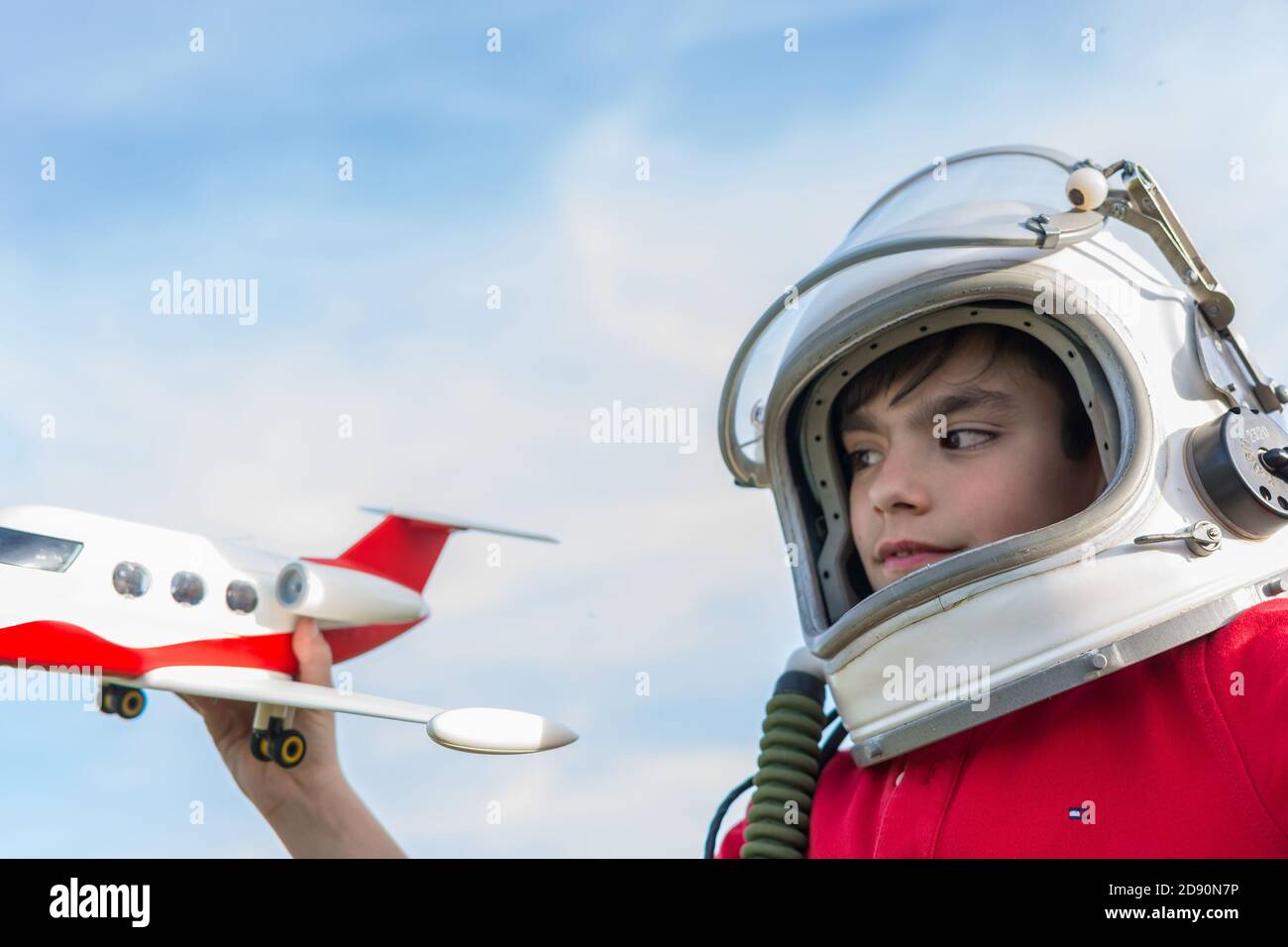 boy with astronaut helmet and plane, playing to be pilot Stock Photo ...