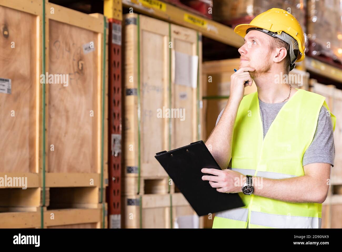 Portrait white caucasian warehouse worker stand with clipboard and pen ...