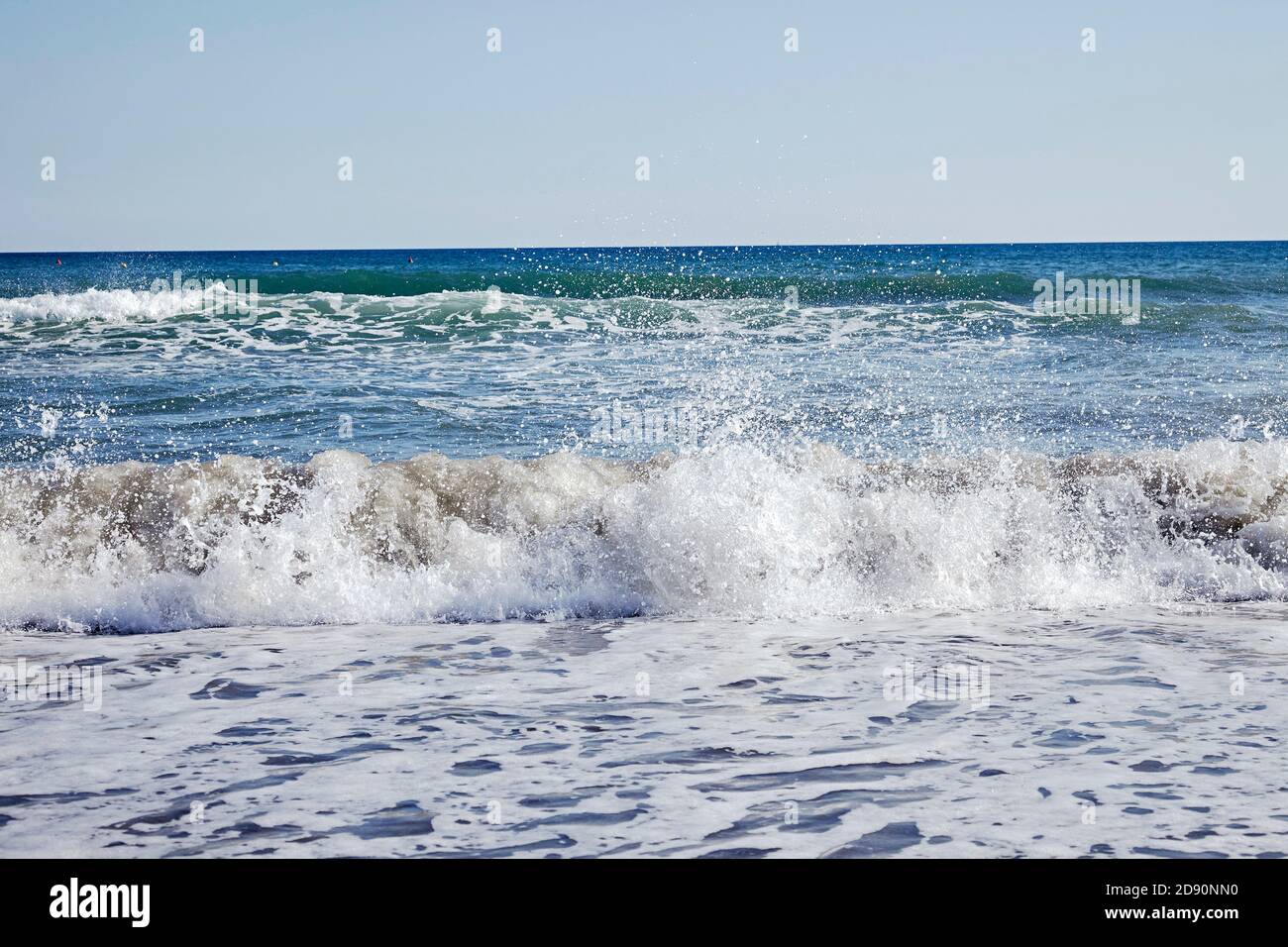 sea waves slamming on the beach and forming foam Stock Photo - Alamy