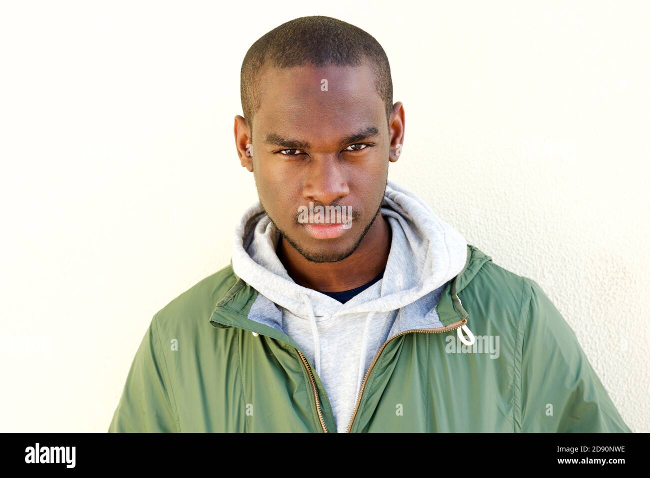 Close up portrait of handsome young black man staring by wall Stock ...