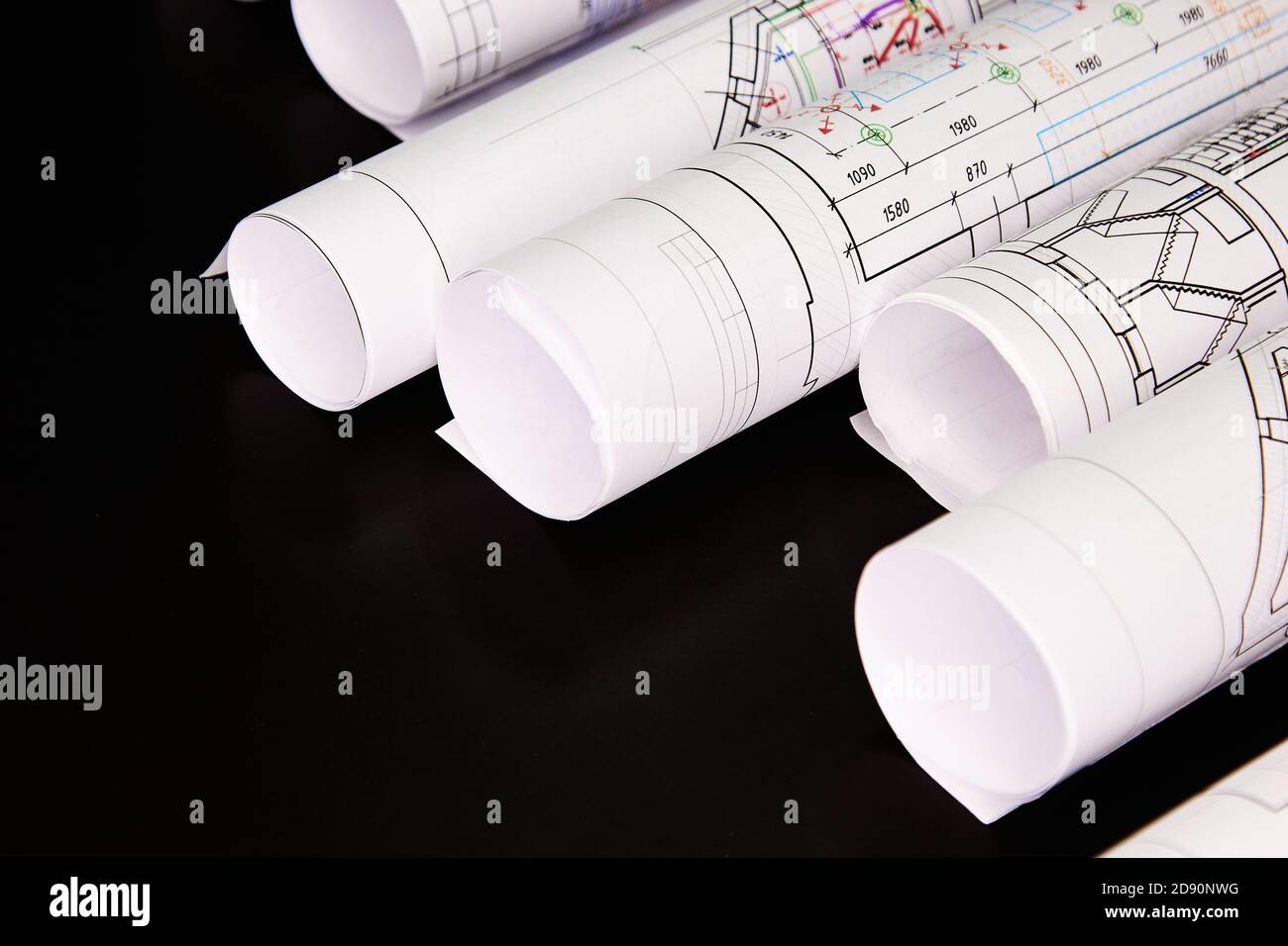 Architectural project, drawings on a dark background. Rolls of project ...