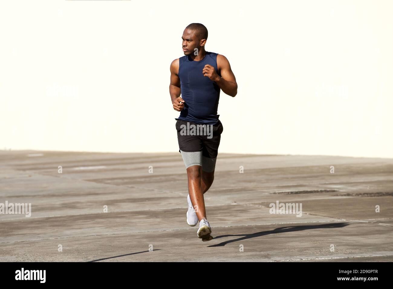 Full length portrait of healthy young black man running outdoors Stock ...