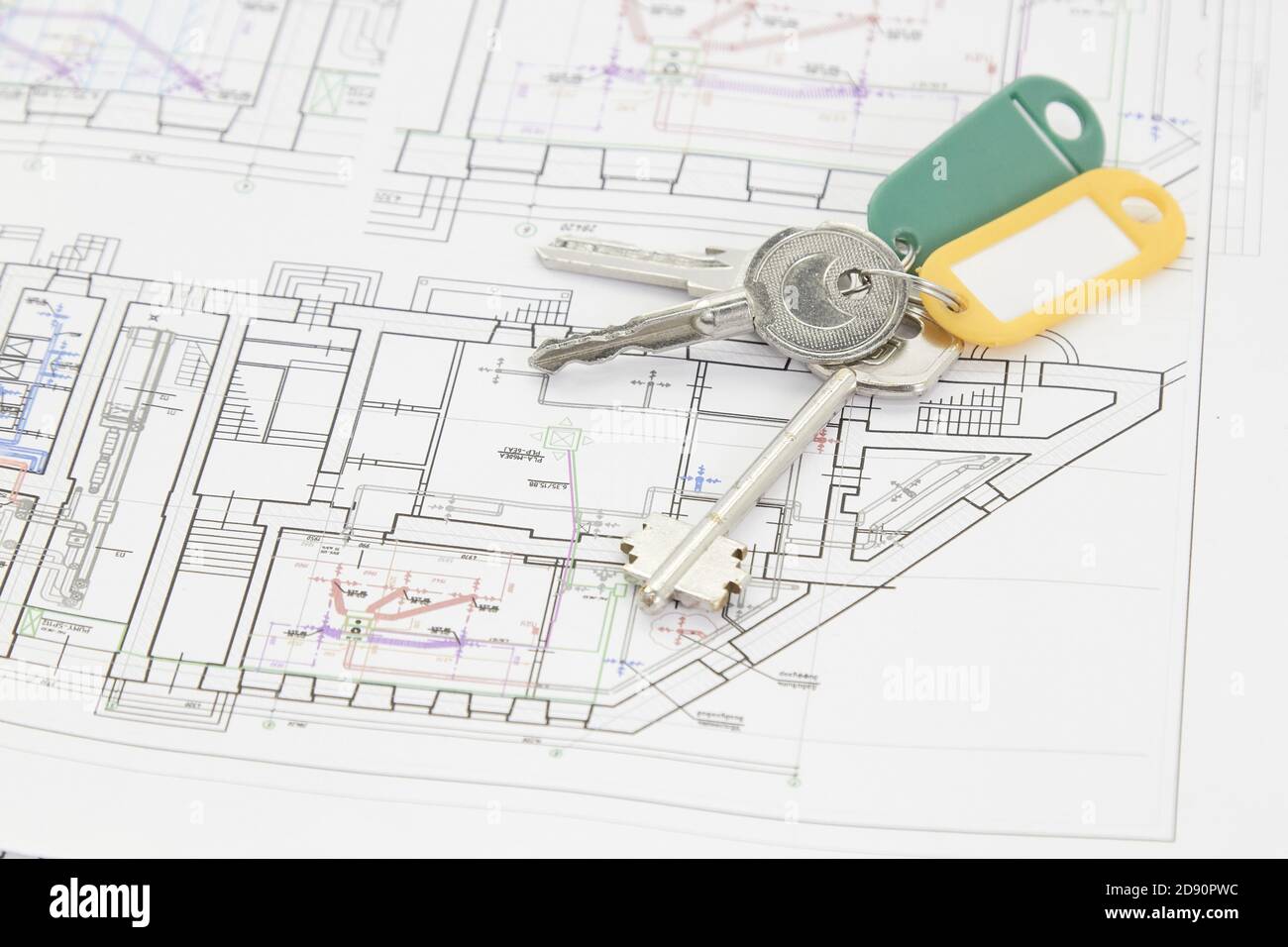 architectural drawings on a white sheet with keys to the house, the ...