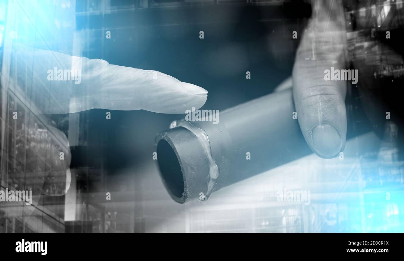 Plumber putting glue on a pvc pipe; light effect Stock Photo - Alamy