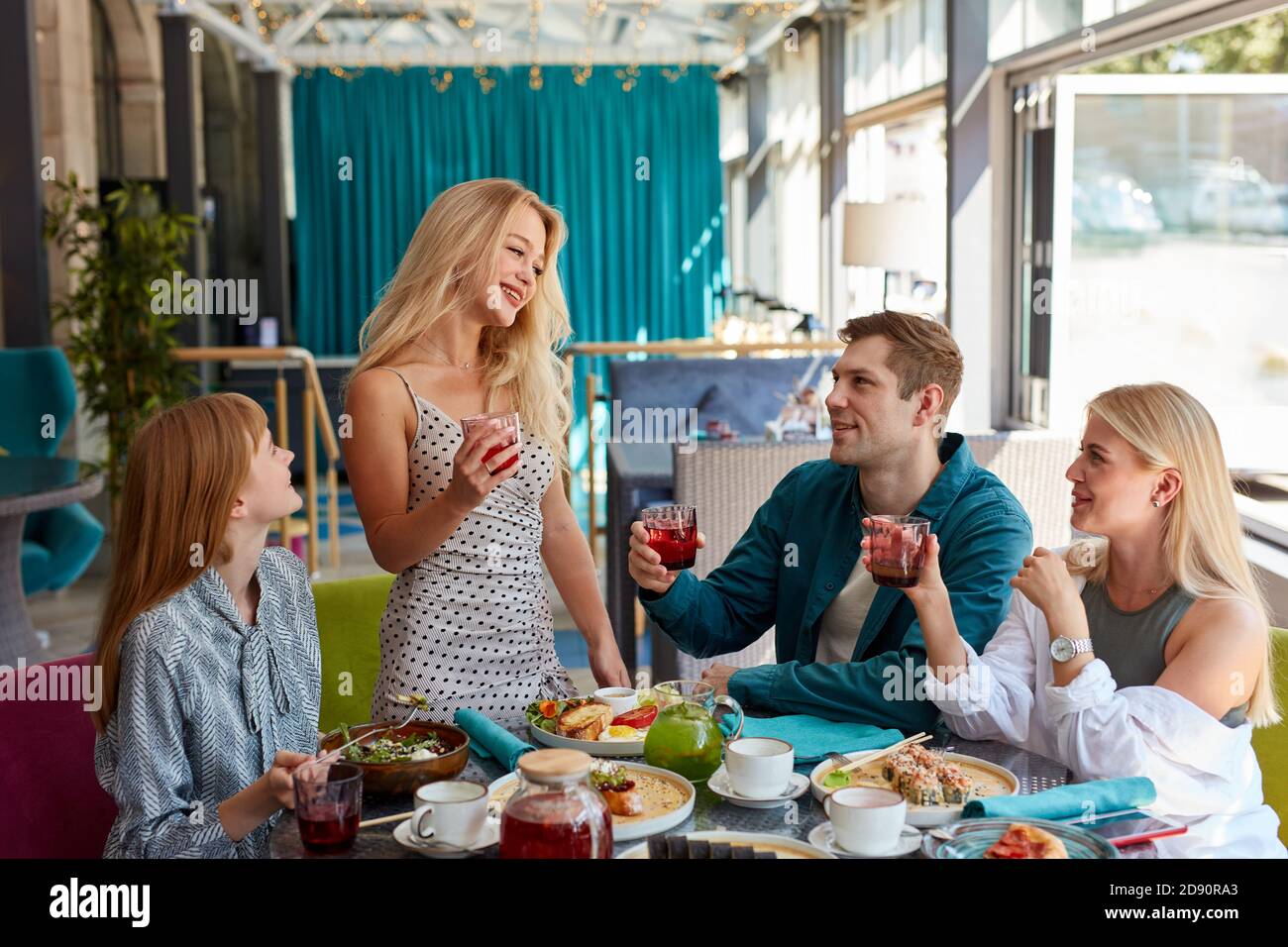 good-looking caucasian woman is talking toast for birthday man ...