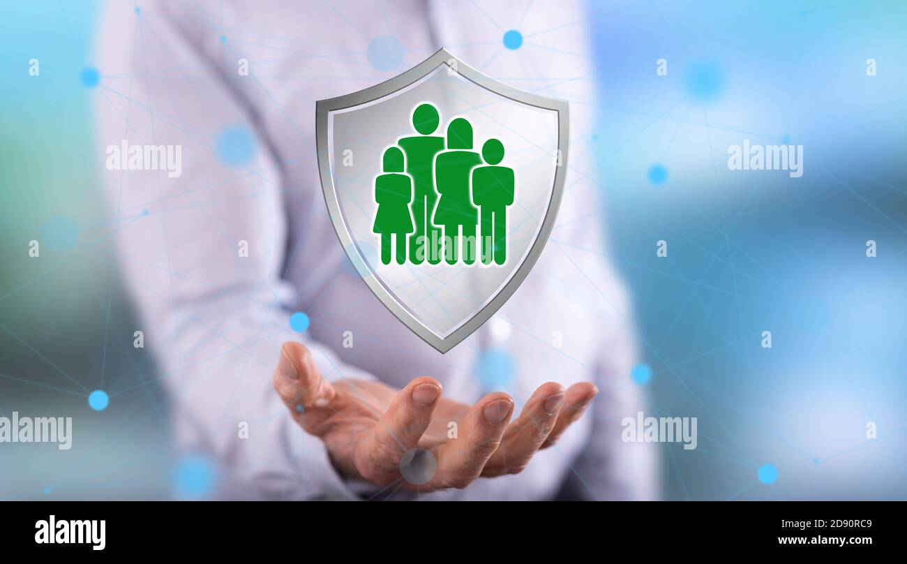 Family protection concept above the hand of a man in background Stock ...
