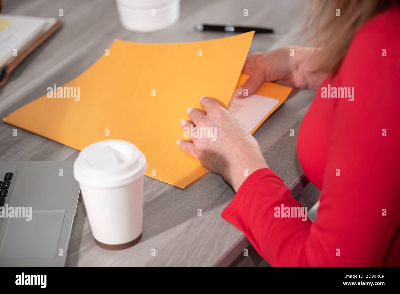 Businesswoman opening folder with paper documents Stock Photo - Alamy