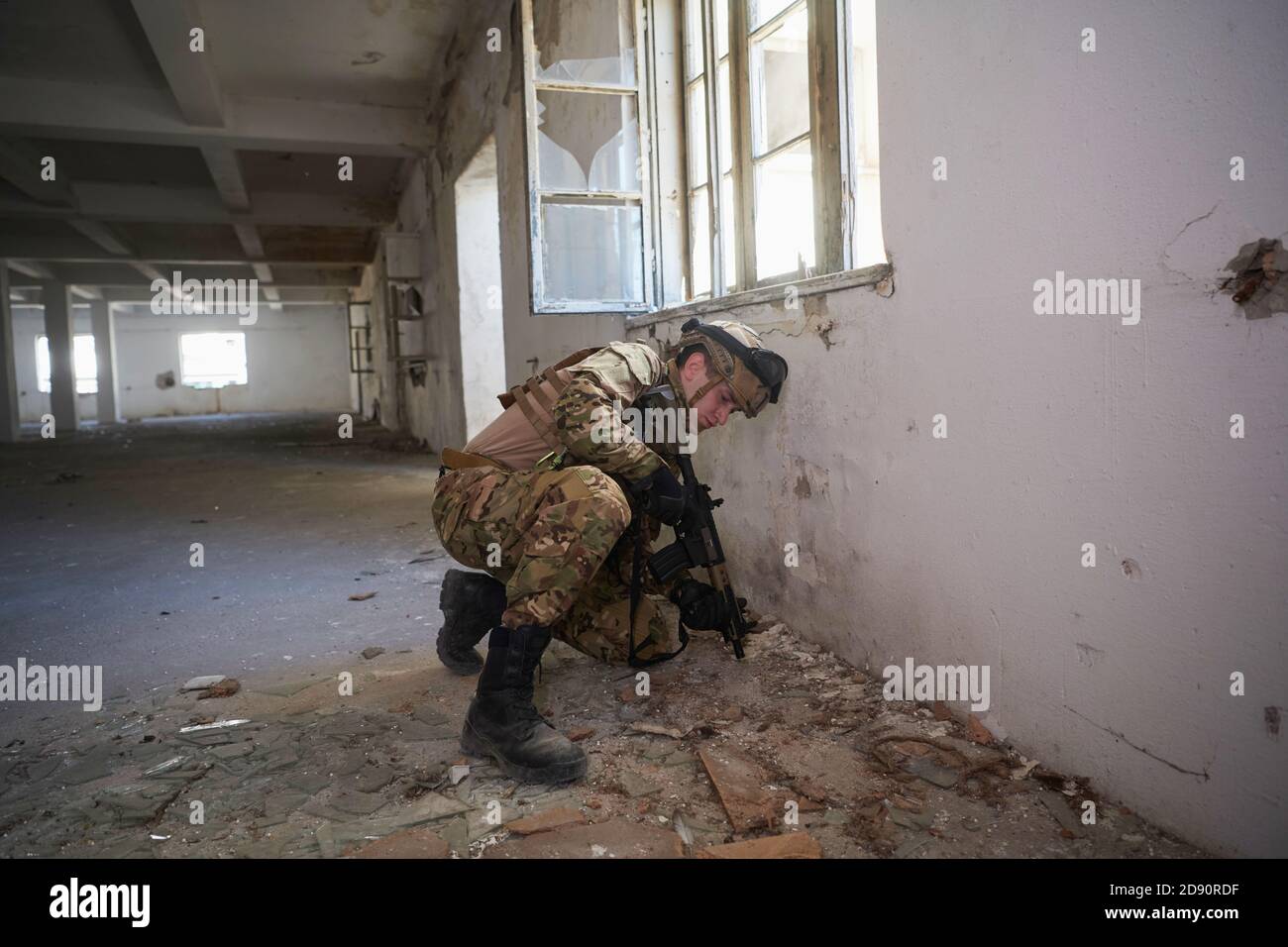 soldier in action near window changing magazine and take cover Stock ...