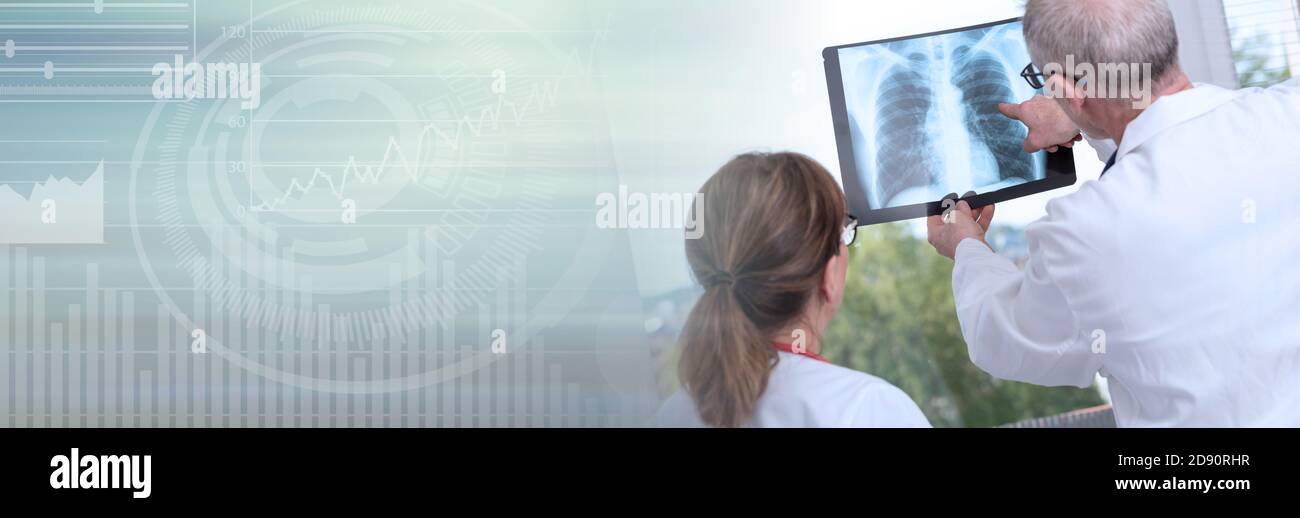 Two doctors examining x-ray report in medical office. panoramic banner ...