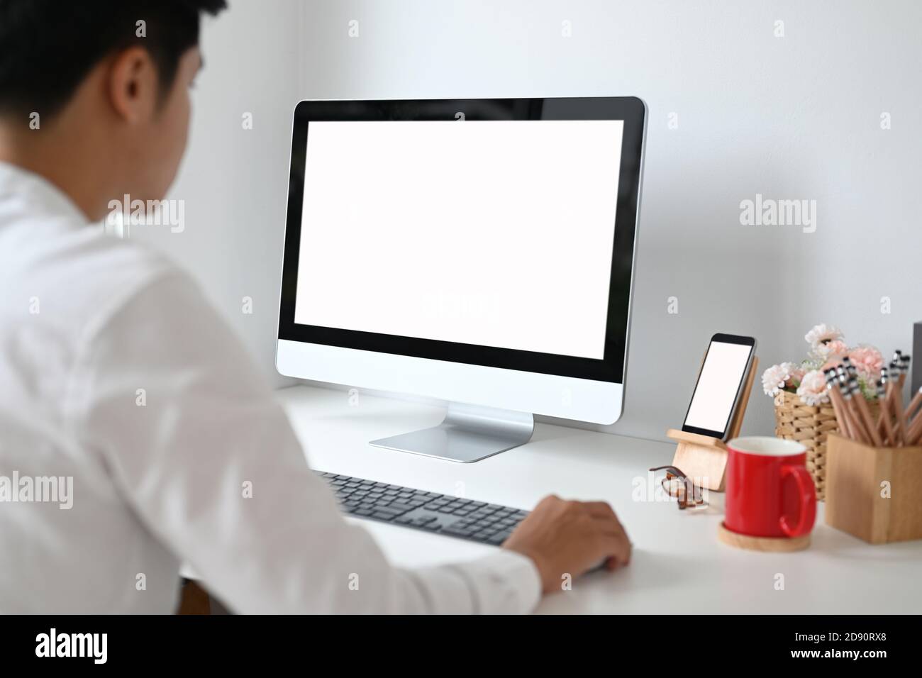 Cropped shot of young man planing his project on computer pc with white ...