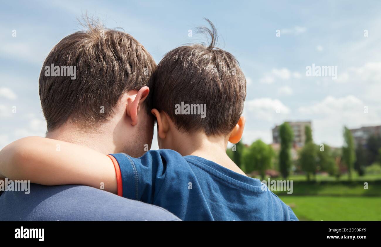 Father and son on a city background. View from the back Stock Photo - Alamy
