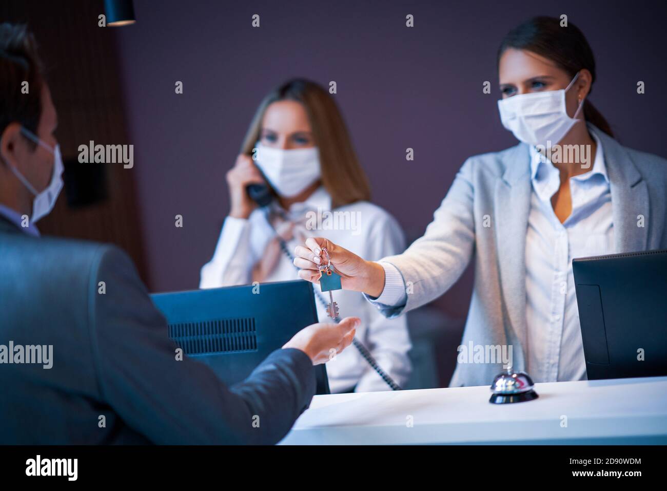 Hotel manager in mask, lobby hi-res stock photography and images - Alamy