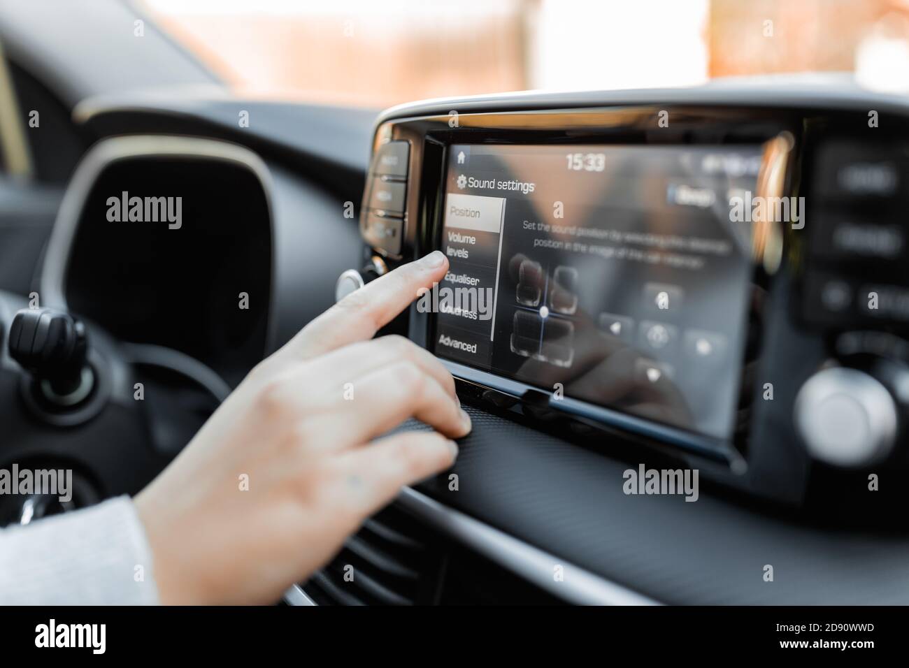 Interior view of brand new car. Driver adjust car's language on the ...