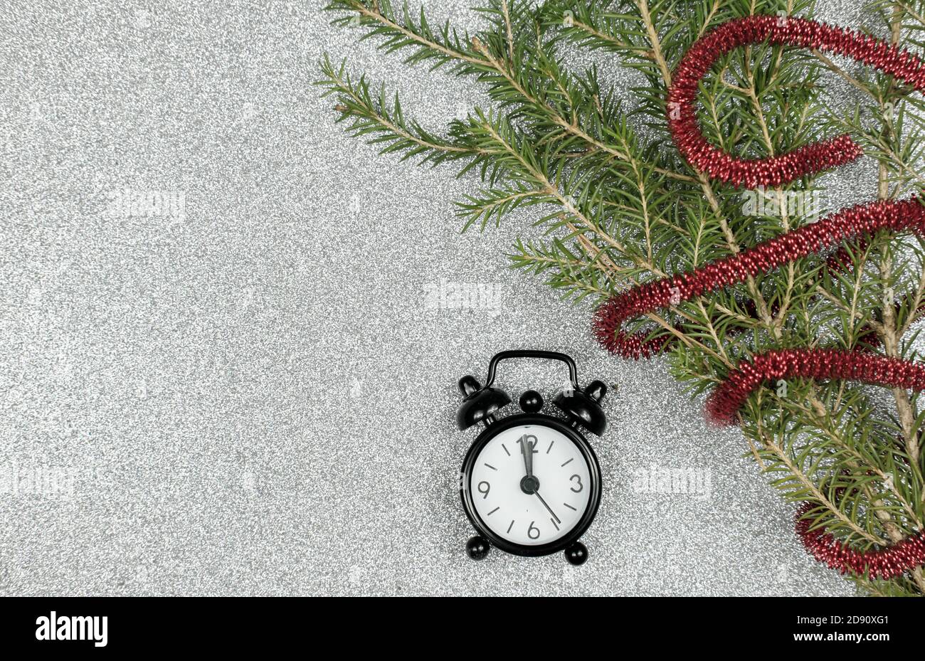 sparkling christmas background with alarm clock and fir tree brand and ...