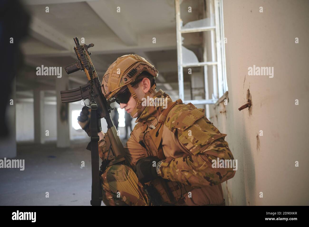 soldier in action near window changing magazine and take cover Stock ...