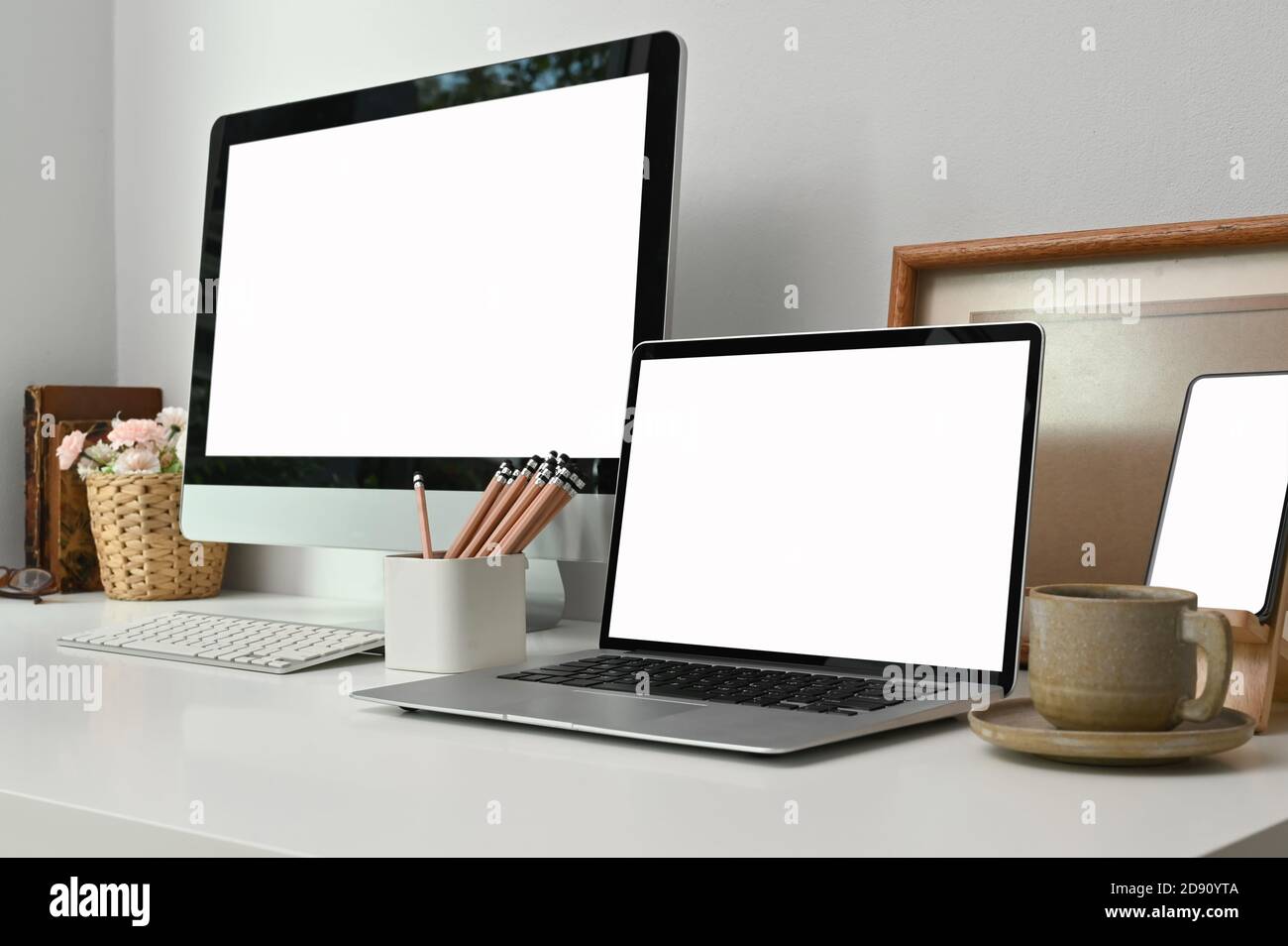 Workspace with mockup blank screen computer pc and laptop on white ...