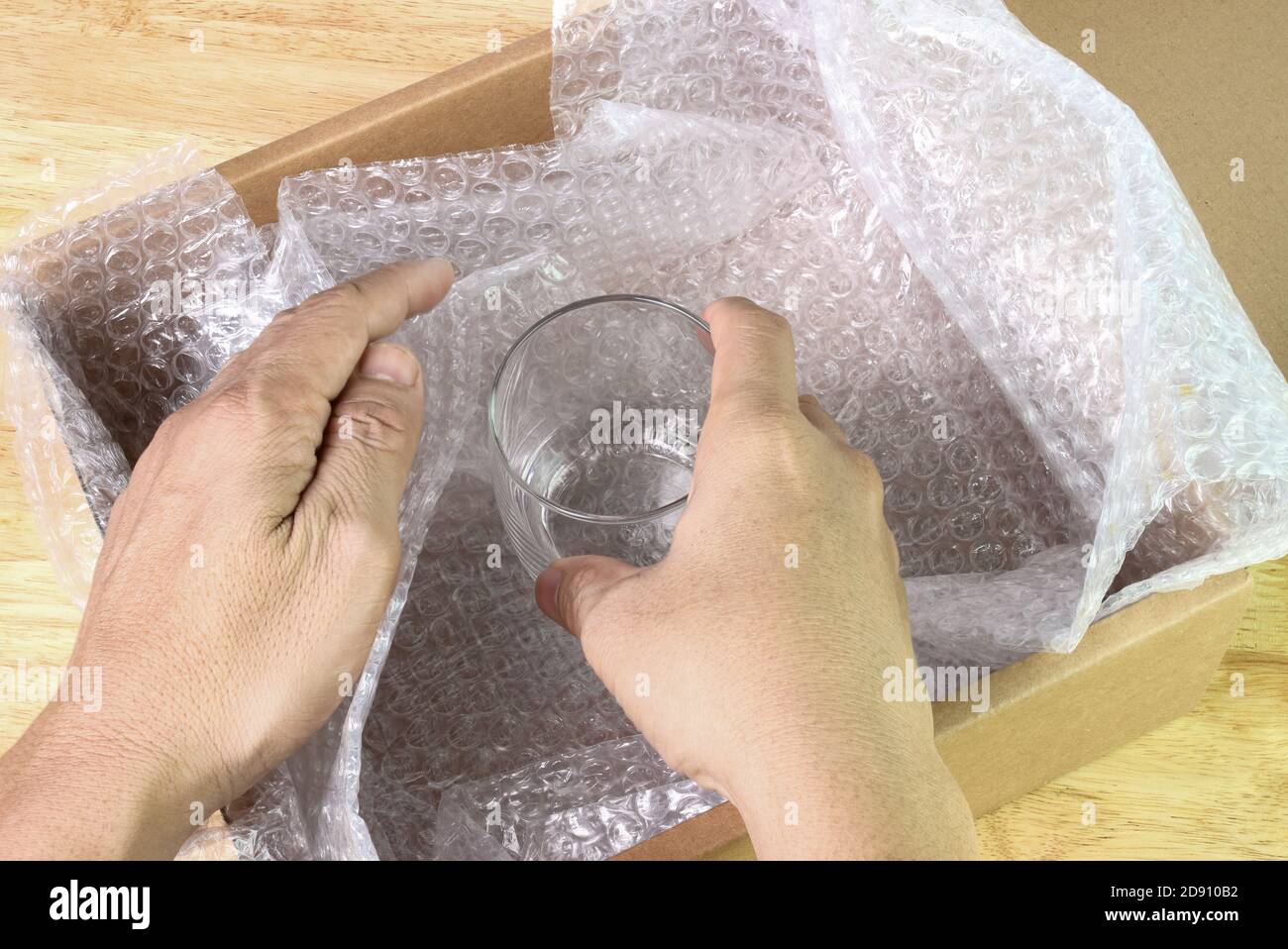 hand of man hold bubble wrap cover glass for protection product cracked ...