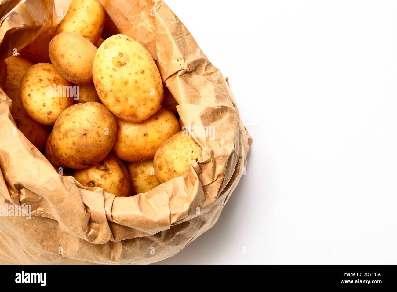 Paper sack of Maris Piper potatoes isolated on a white background with ...
