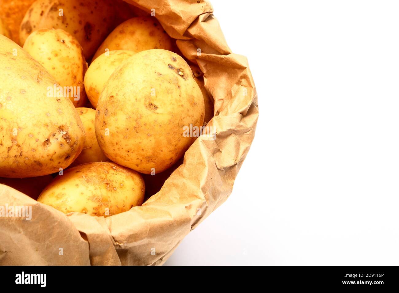 Paper sack of Maris Piper potatoes isolated on a white background with ...
