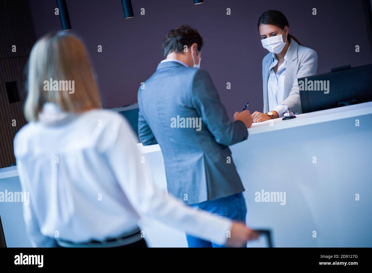 Hotel manager in mask, lobby hi-res stock photography and images - Alamy