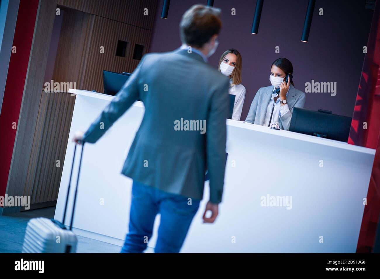 Hotel manager in mask, lobby hi-res stock photography and images - Alamy