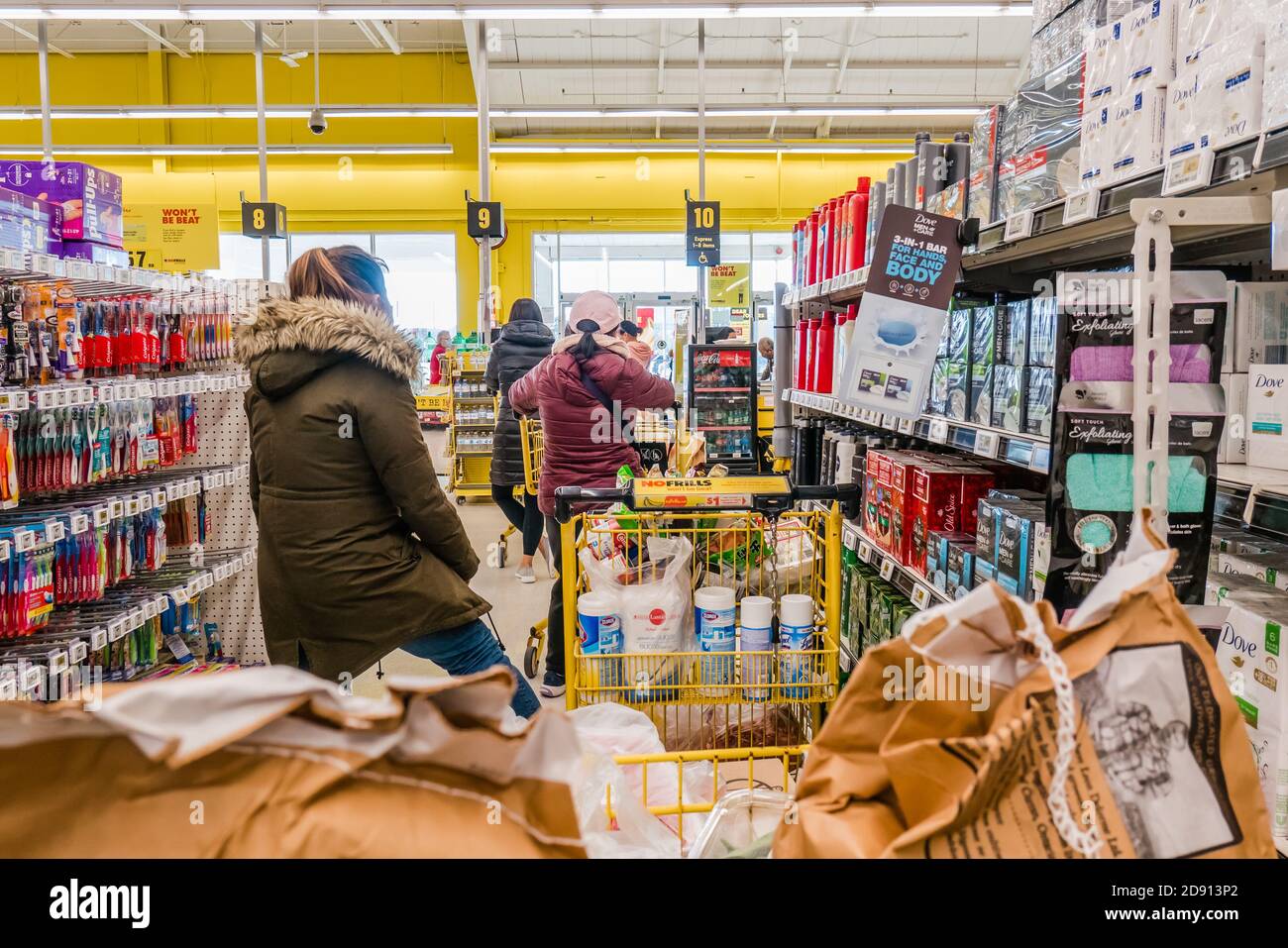 shoppers lineinng up to check out inside a supermarket checkout line ...