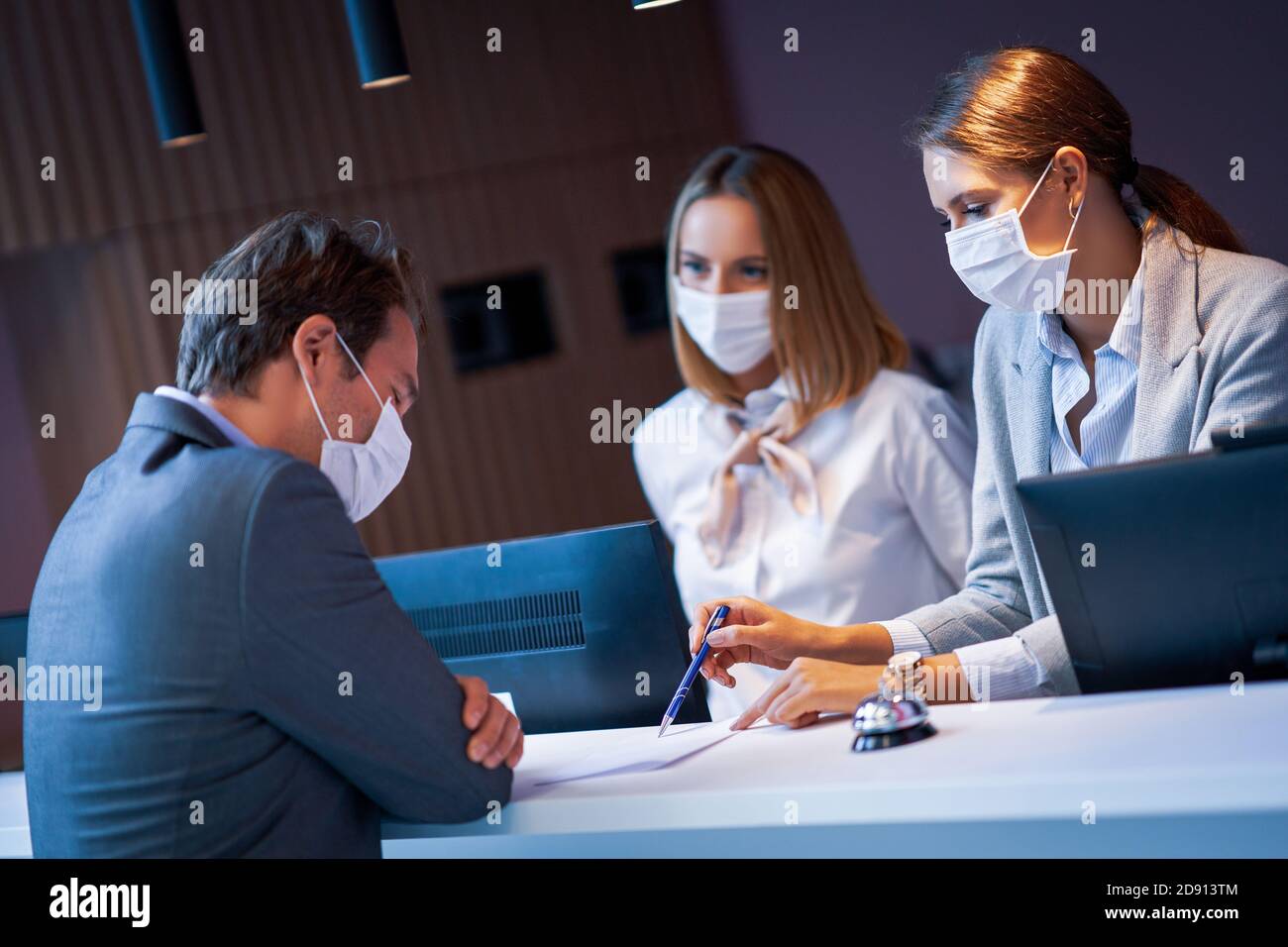 Hotel manager in mask, lobby hi-res stock photography and images - Alamy
