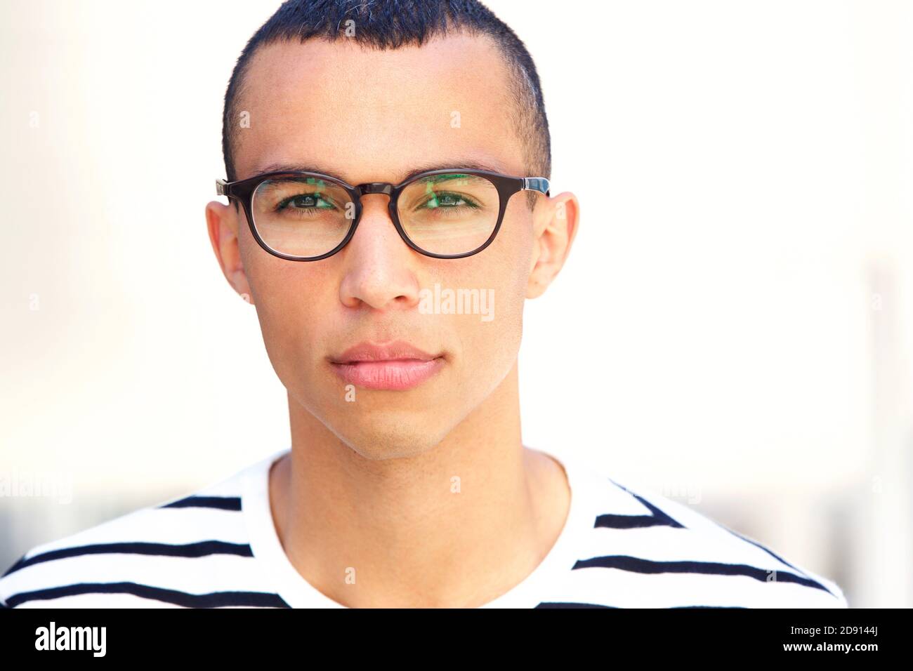 Close up front portrait of serious young man with glasses Stock Photo ...