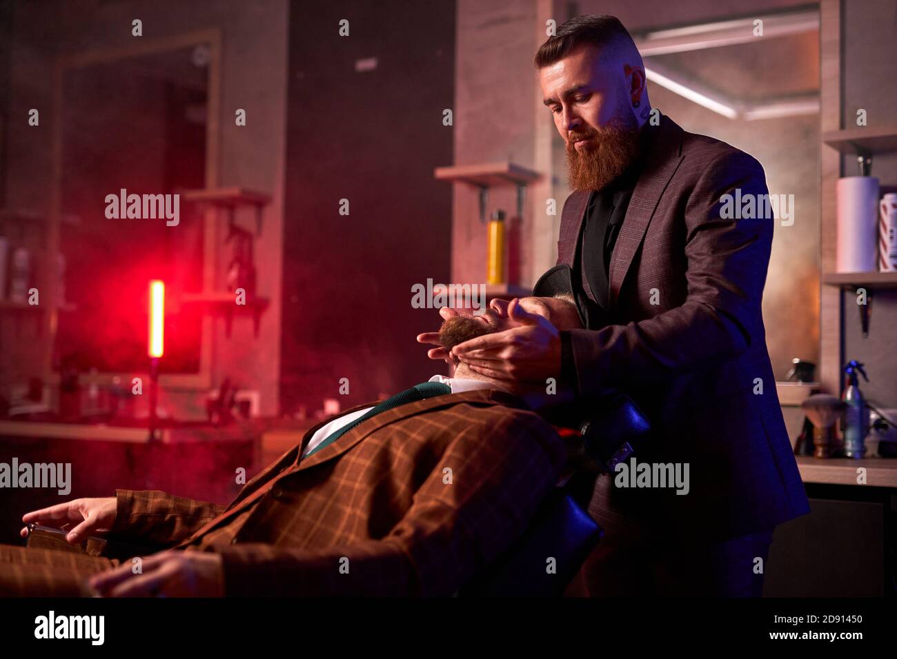 confident male barber preparing client for cutting beard, hairdresser ...