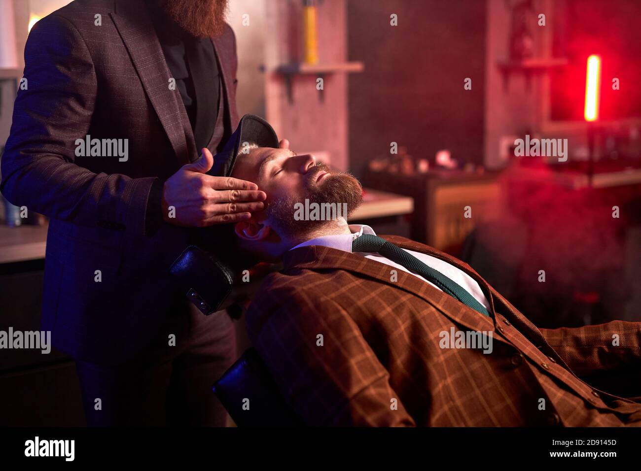 confident male barber preparing client for cutting beard, hairdresser ...