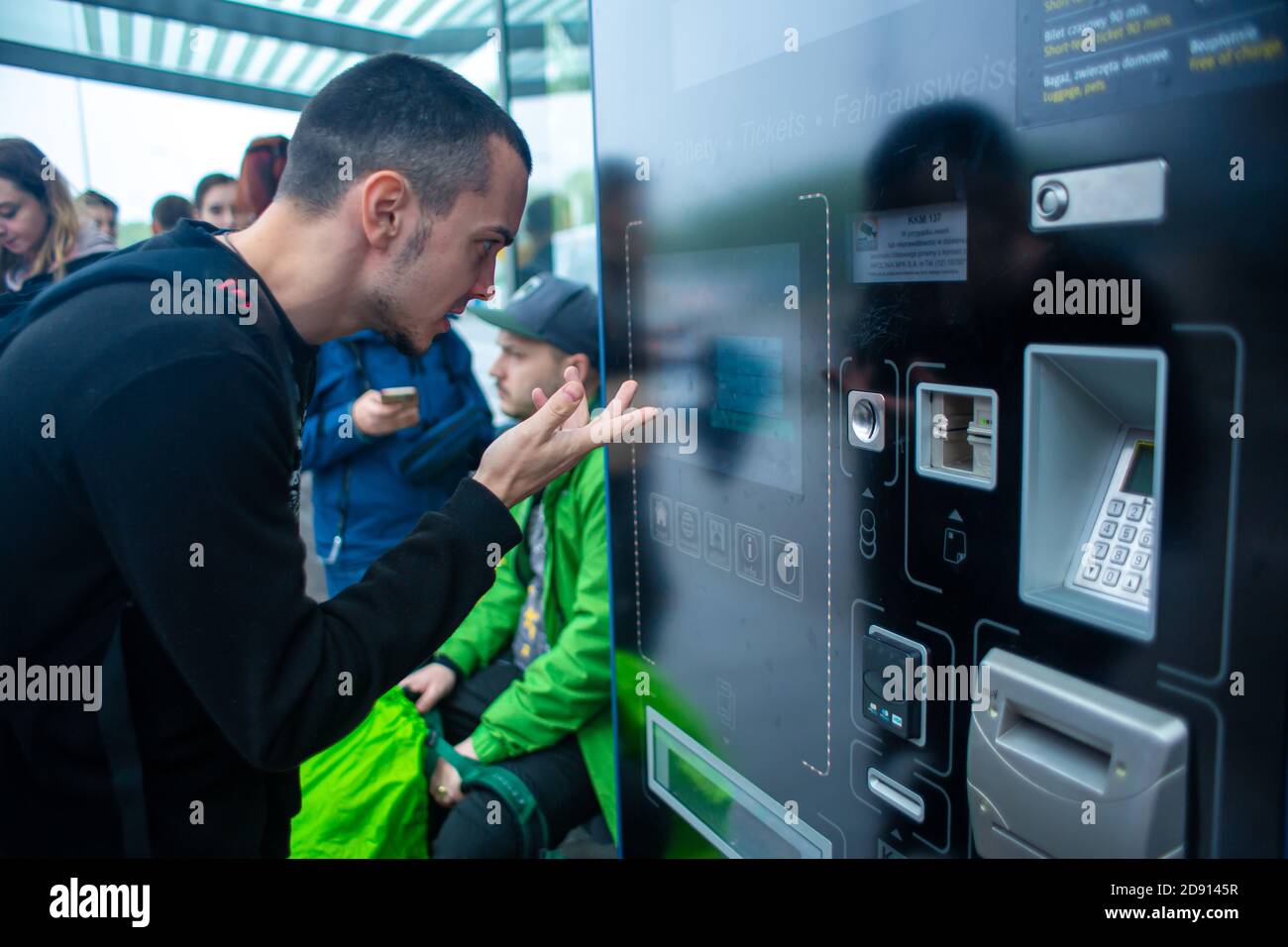 A tourist guy buys a bus ticket for the first time using an electronic ...