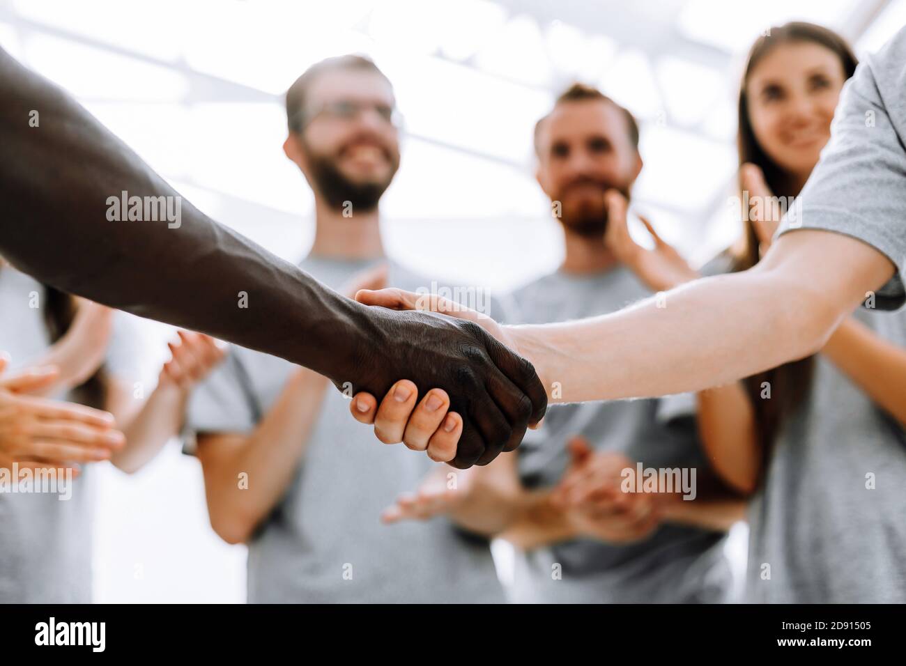 close up. strong handshake of two students of different nationalities ...
