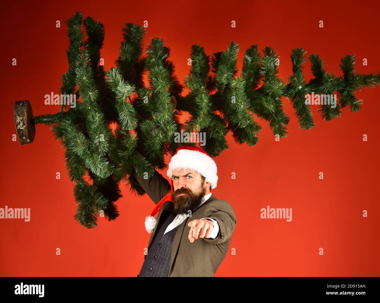 Businessman carrying christmas tree on red background. Office Christmas ...