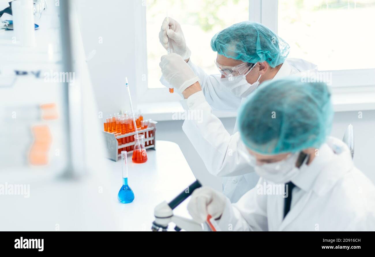 close up. group of scientists sitting at a laboratory table Stock Photo ...