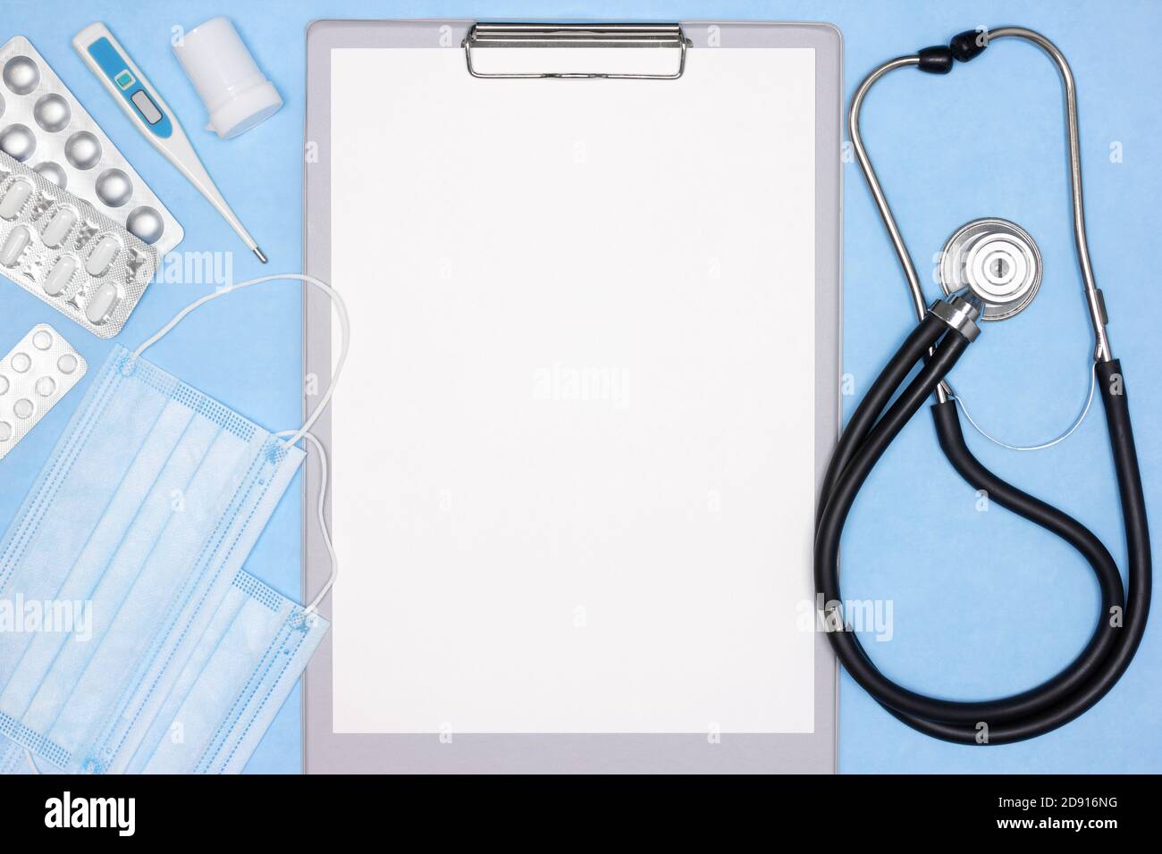 Blank patient medical history, stethoscope, face masks, digital body ...