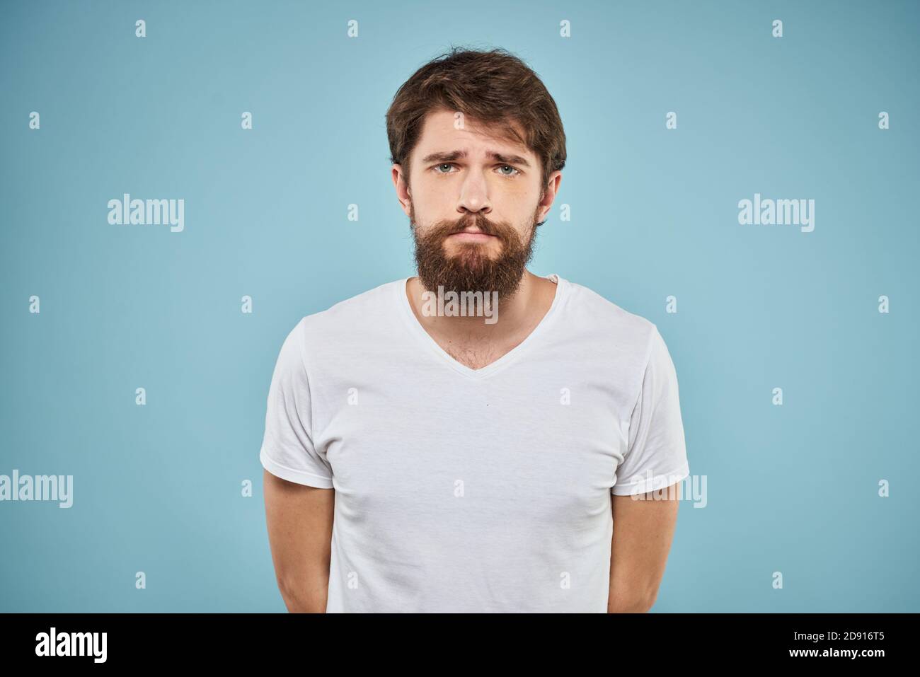 Man in white t-shirt lifestyle studio emotions facial expression blue ...