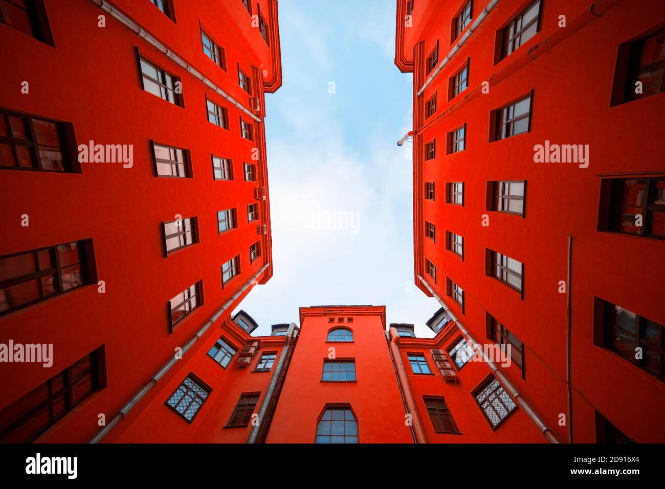 Red house with residential apartments, building with red facade ...