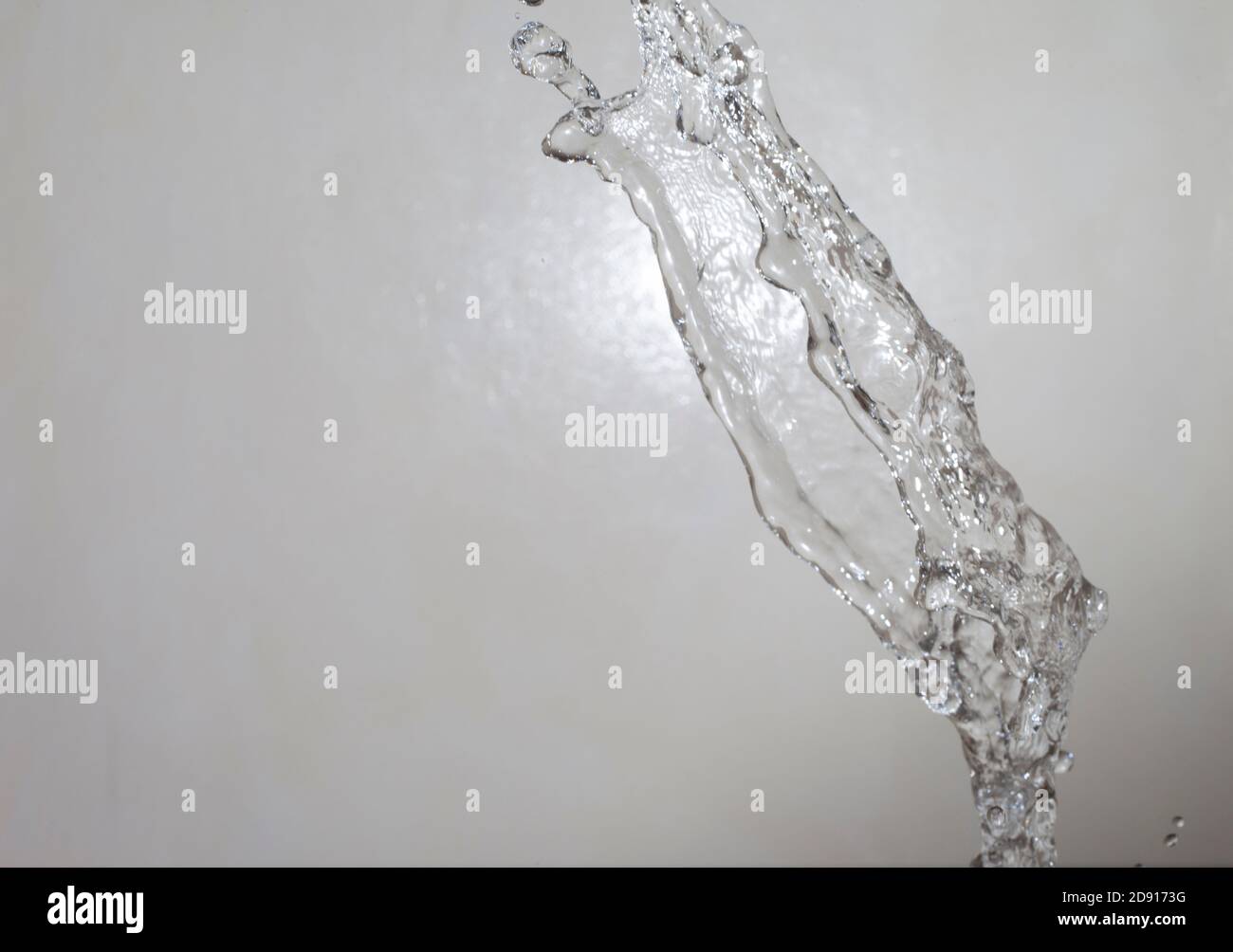 splash of water coming out of the glass Stock Photo - Alamy
