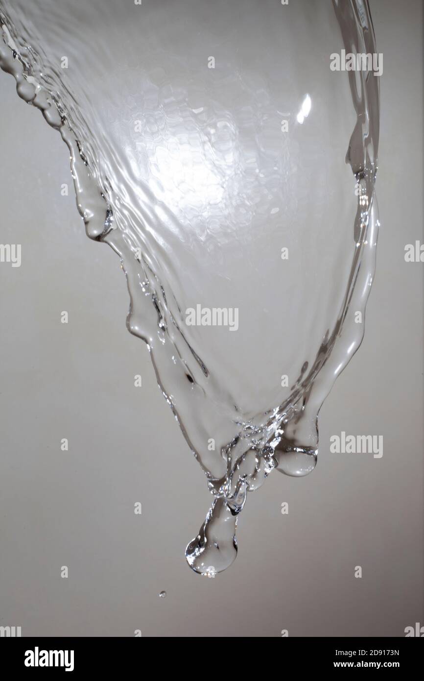 splash of water coming out of the glass Stock Photo - Alamy