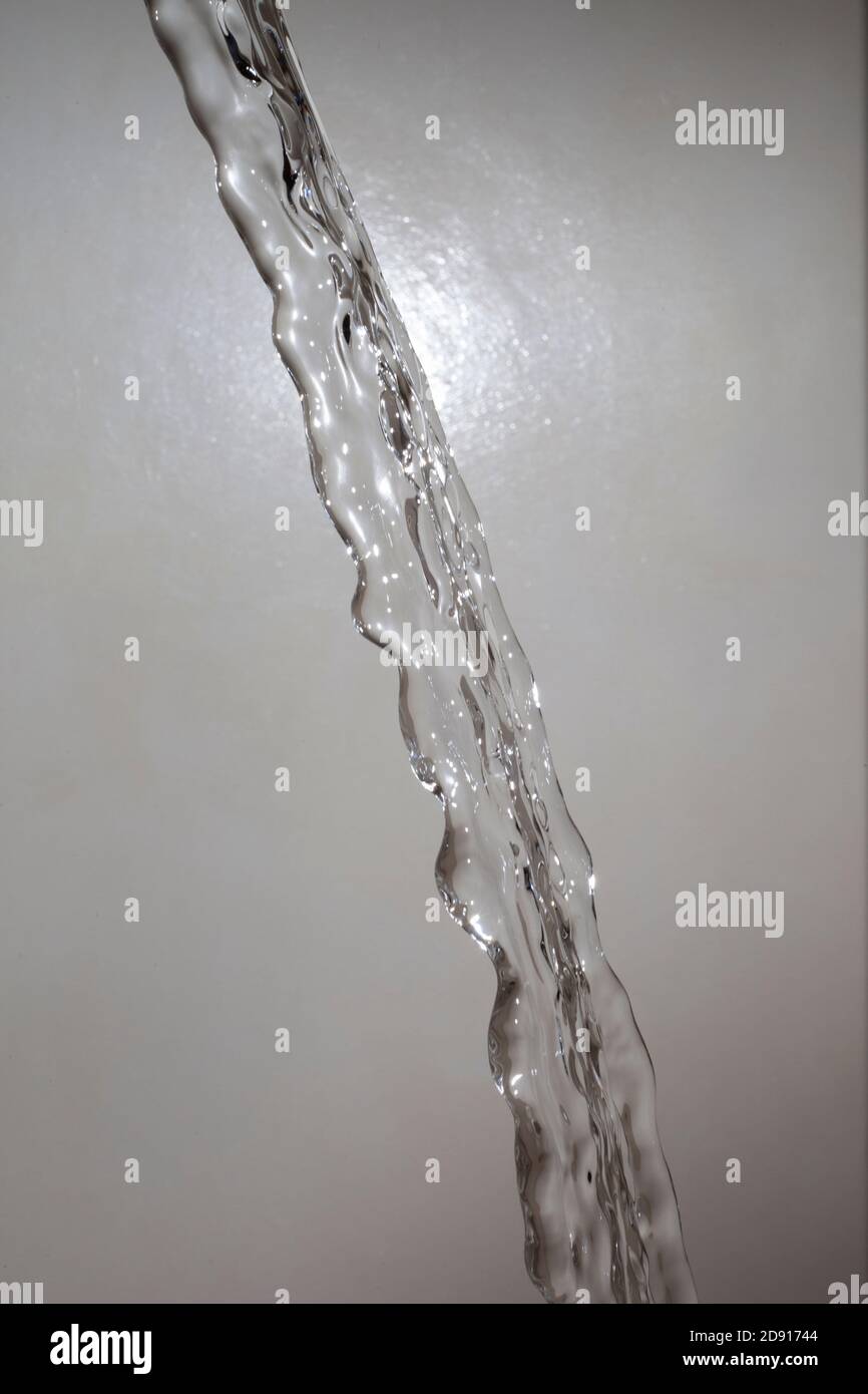 splash of water coming out of the glass Stock Photo - Alamy