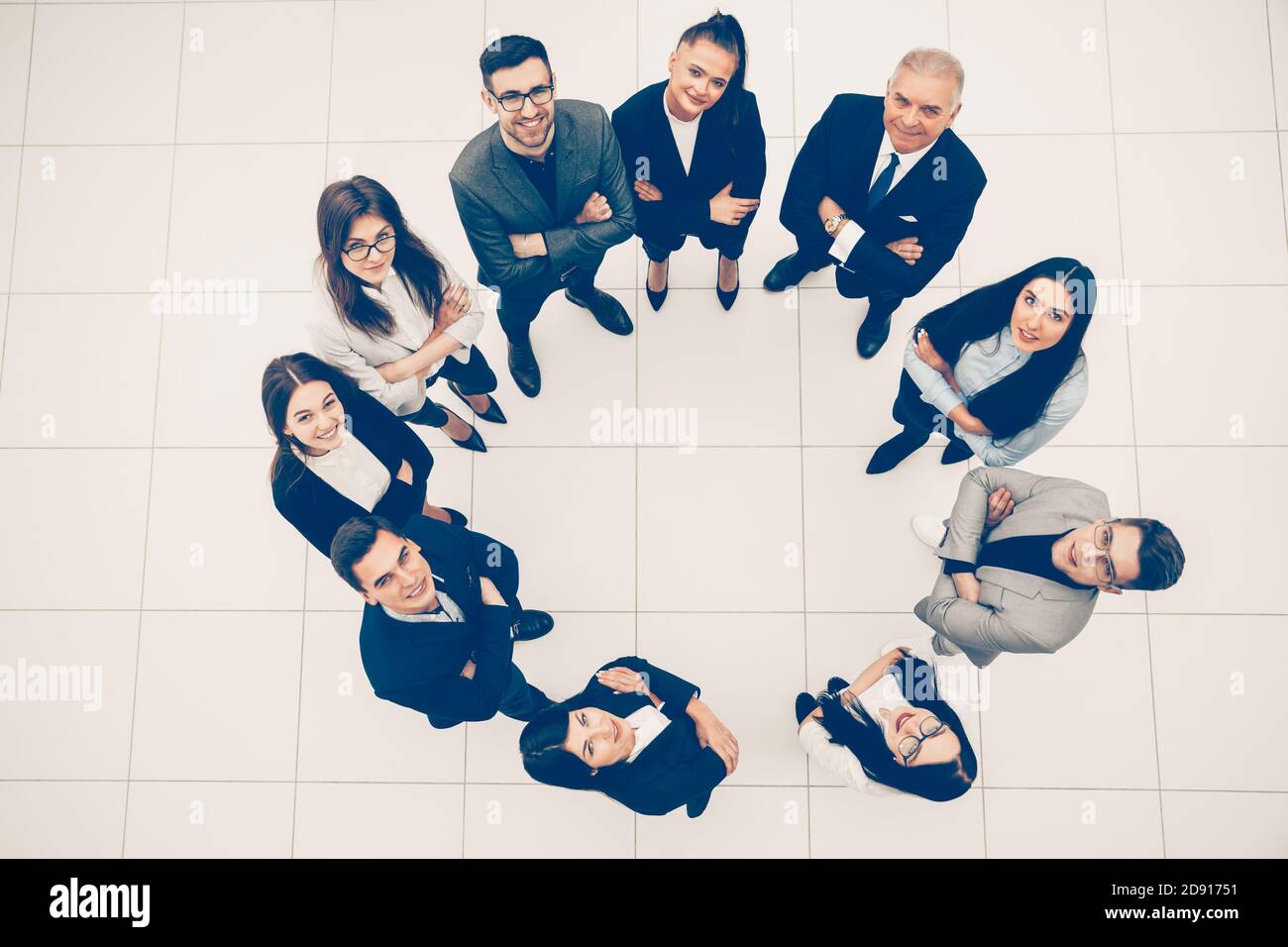 top view. business team standing in a circle and looking at the camera ...