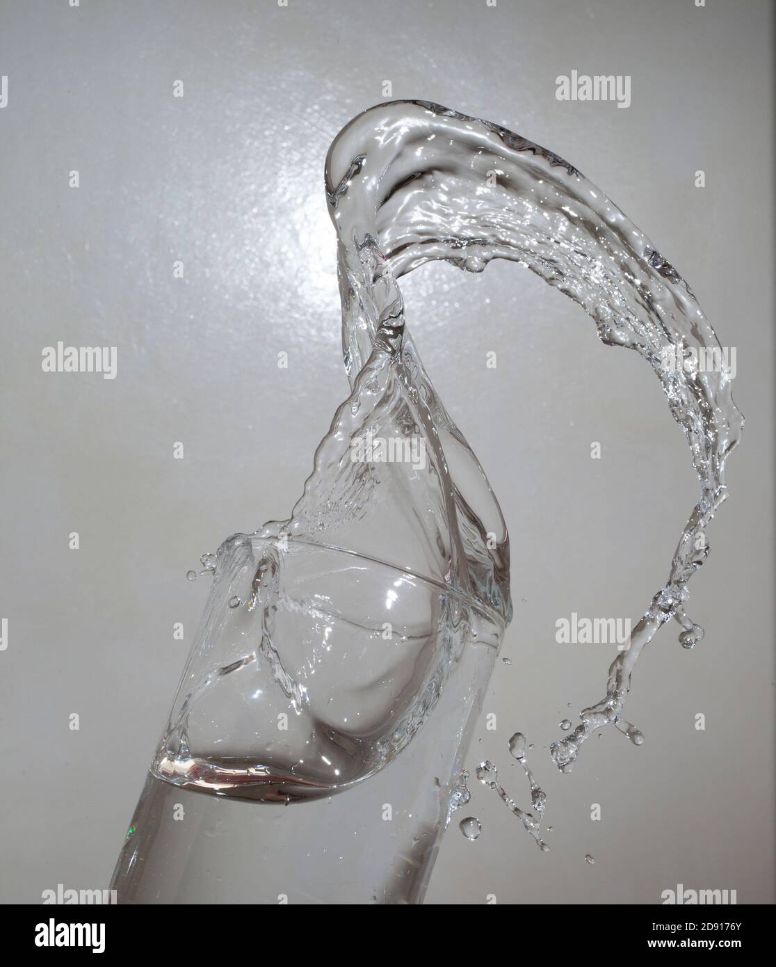 splash of water coming out of the glass Stock Photo - Alamy