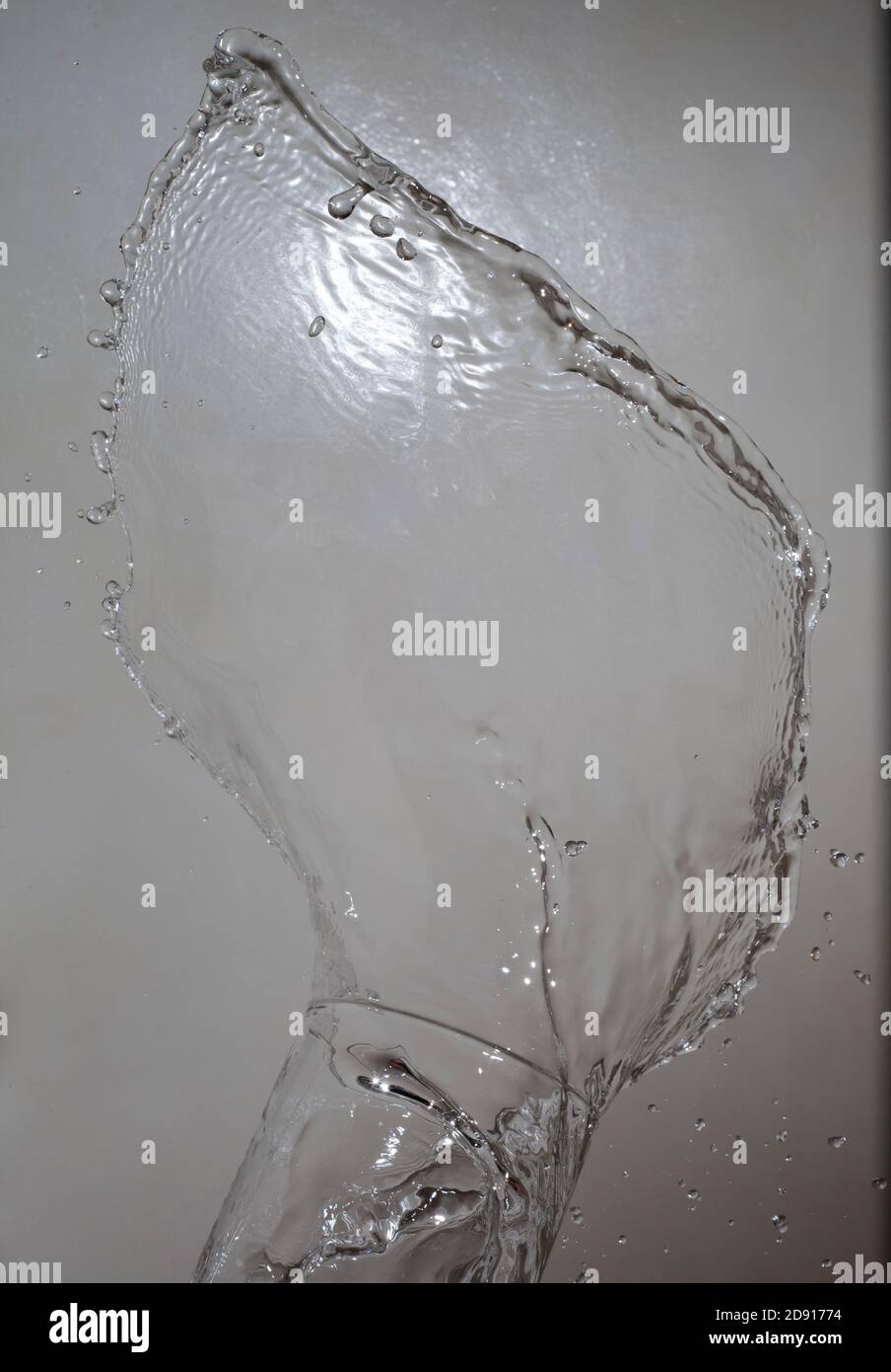 splash of water coming out of the glass Stock Photo - Alamy