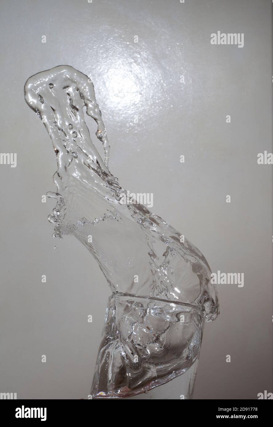splash of water coming out of the glass Stock Photo - Alamy