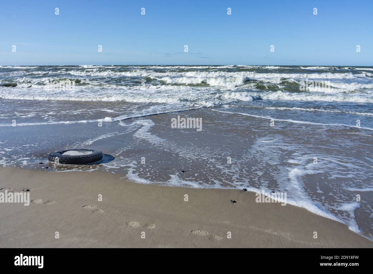 Baltic sea coast, small waves on the sea, ships on the sea horizon, car ...