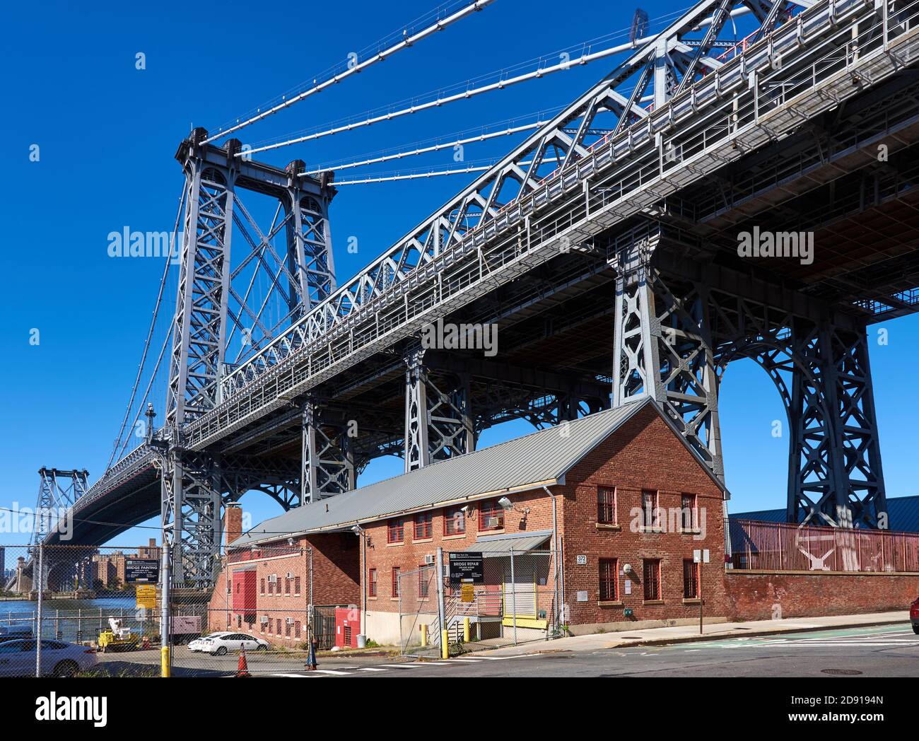 Looking up at the Williamsburg Bridge as it crosses the East River to the Lower East Side of ...