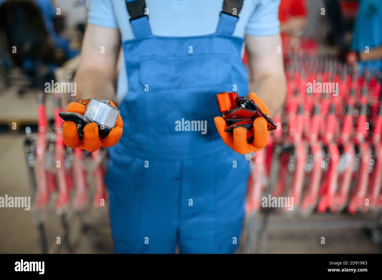 Bicycle factory, worker shows bike reflectors Stock Photo - Alamy