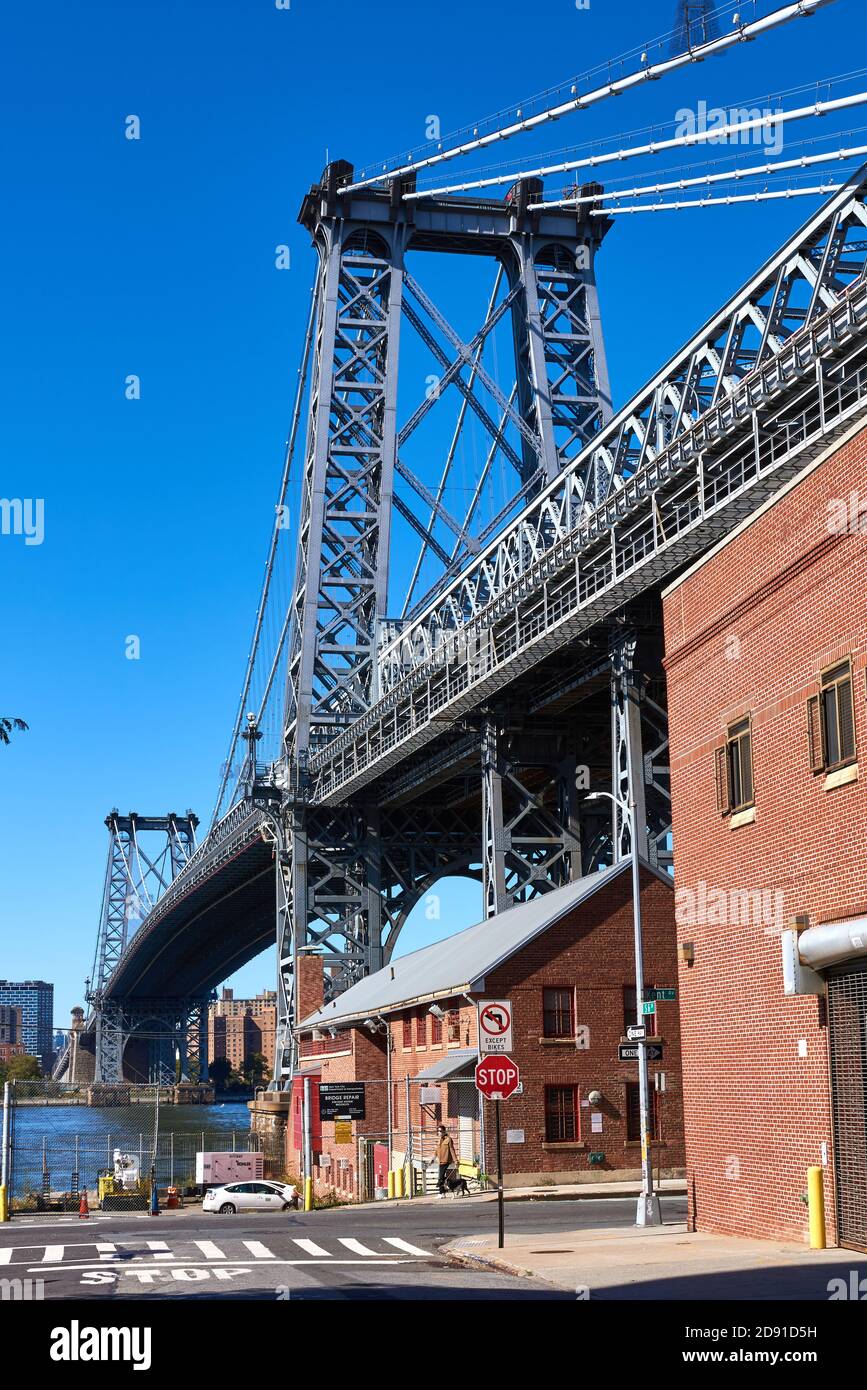 Looking up at the Williamsburg Bridge as it crosses the East River to the Lower East Side of ...